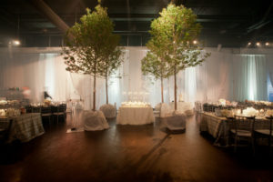 Large trees incorporated into the reception decor - Today's Bride